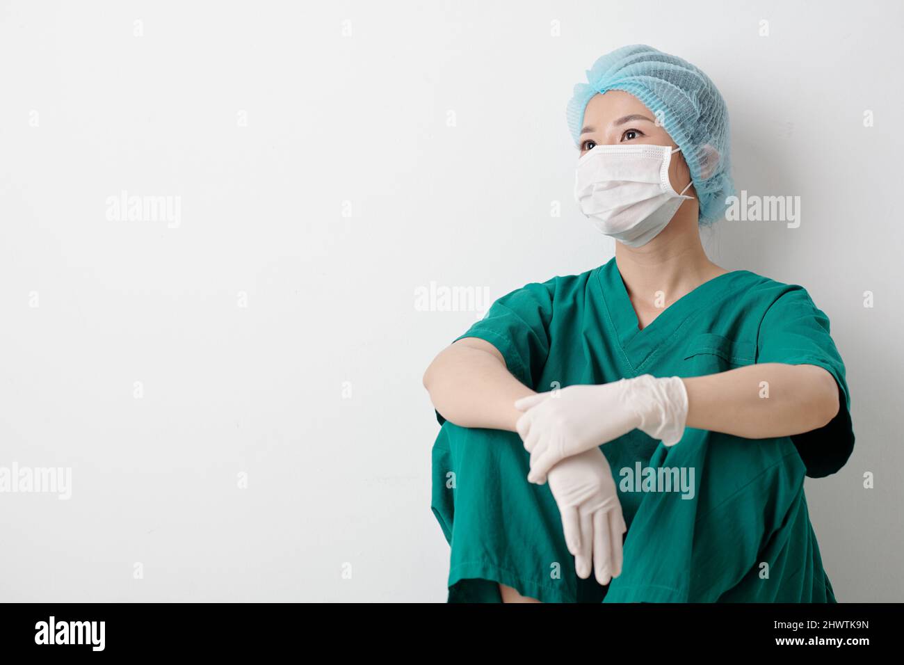 Positive young Asian surgeon resting after successful surgery Stock ...