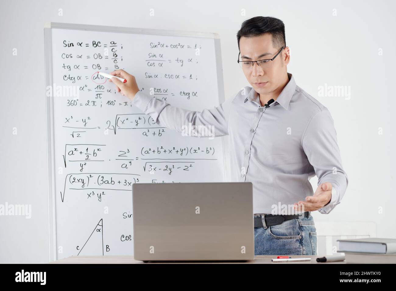 Mathematics teacher answering question of student and explaining every ...