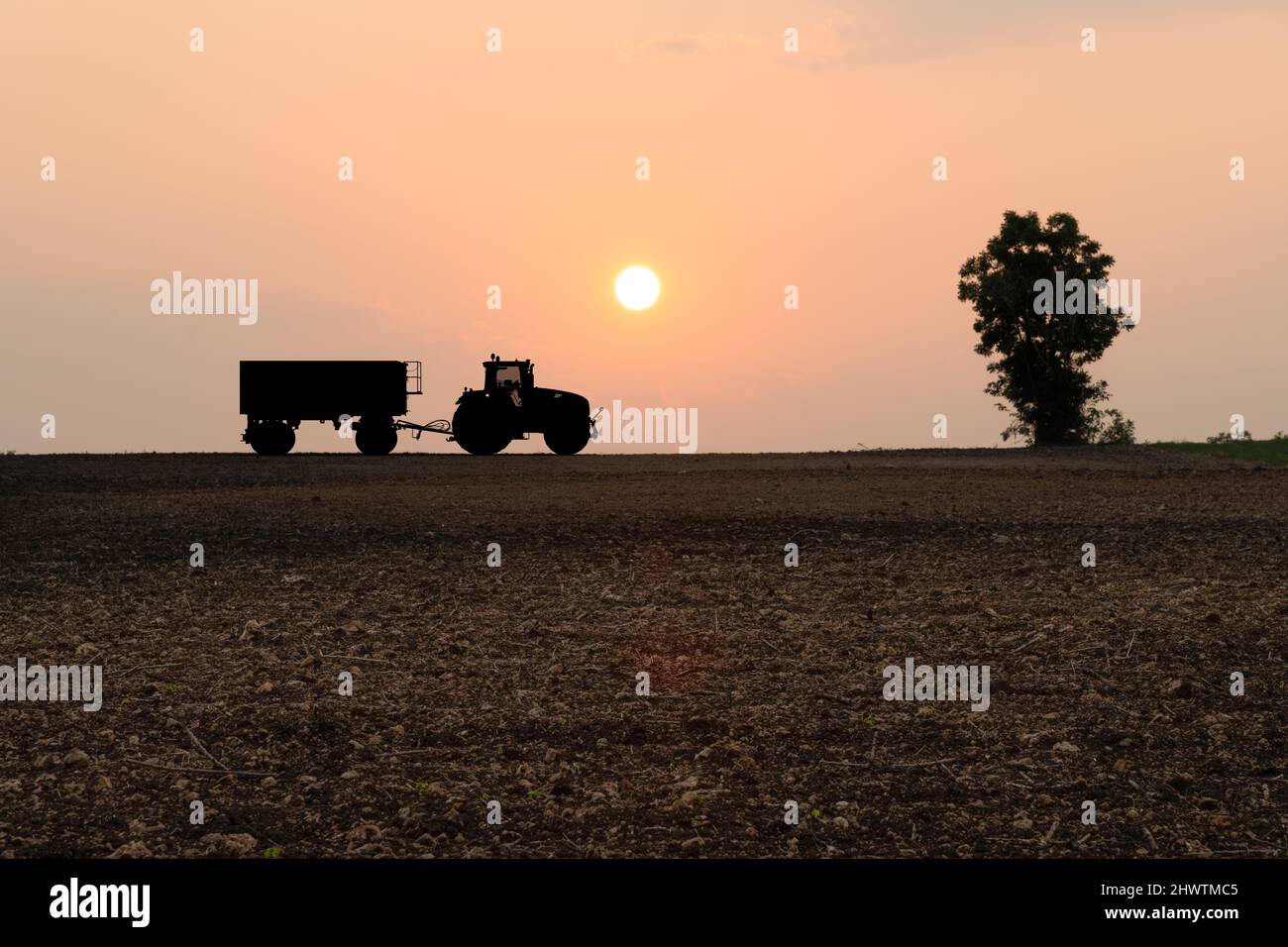 Silhouette tractor at hill farm Stock Photo - Alamy