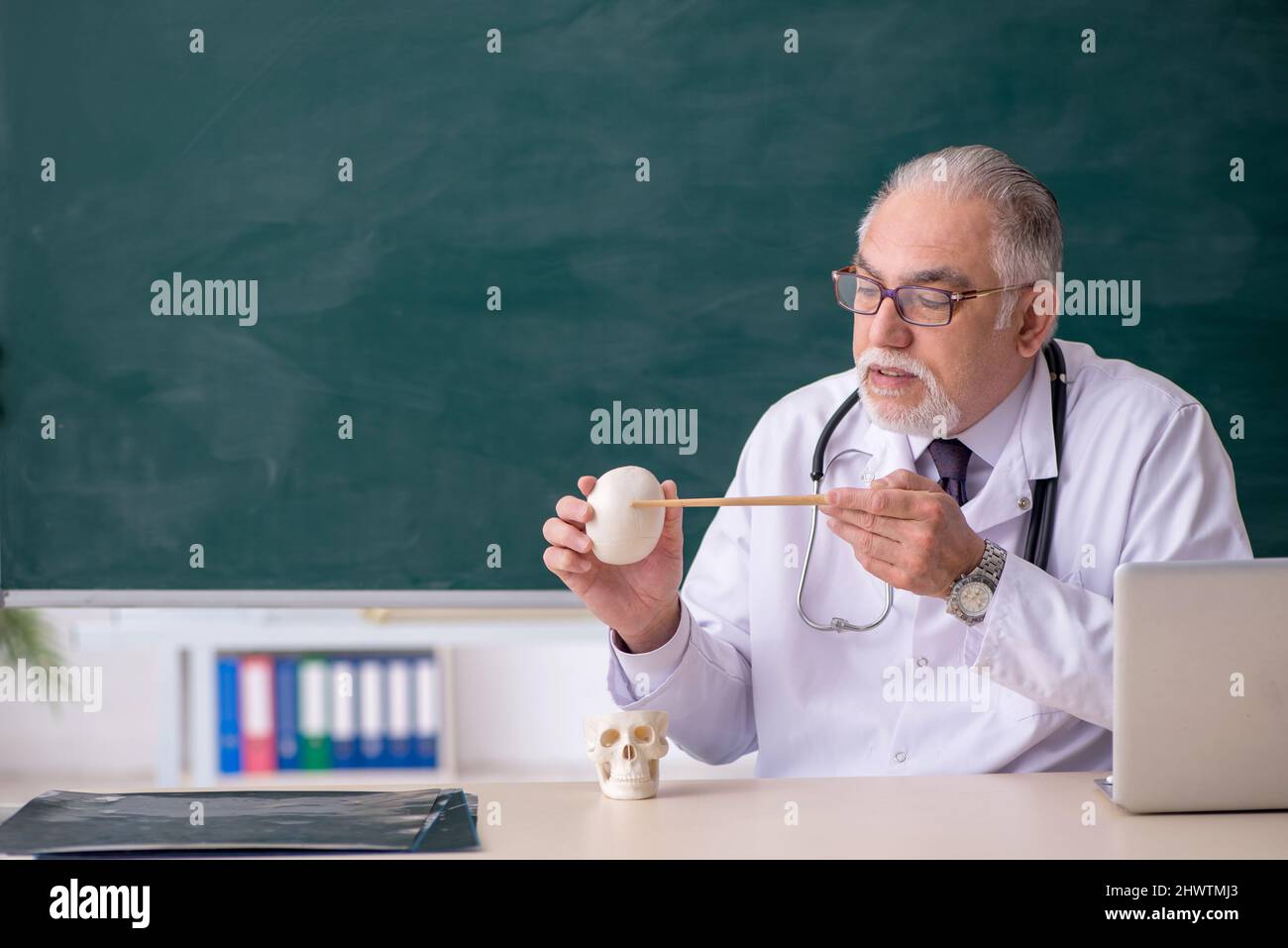 Old doctor teacher in front of blackboard Stock Photo - Alamy