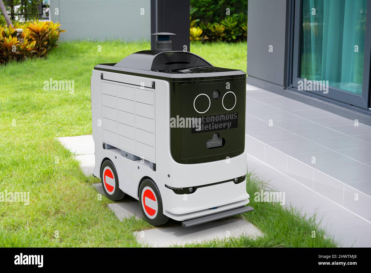Autonomous parcel delivery robot parked in front of customer house ...