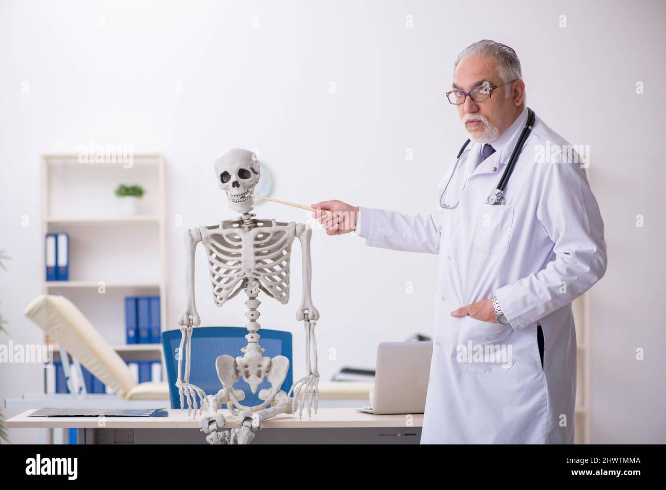 Old doctor demonstrating human skeleton Stock Photo - Alamy