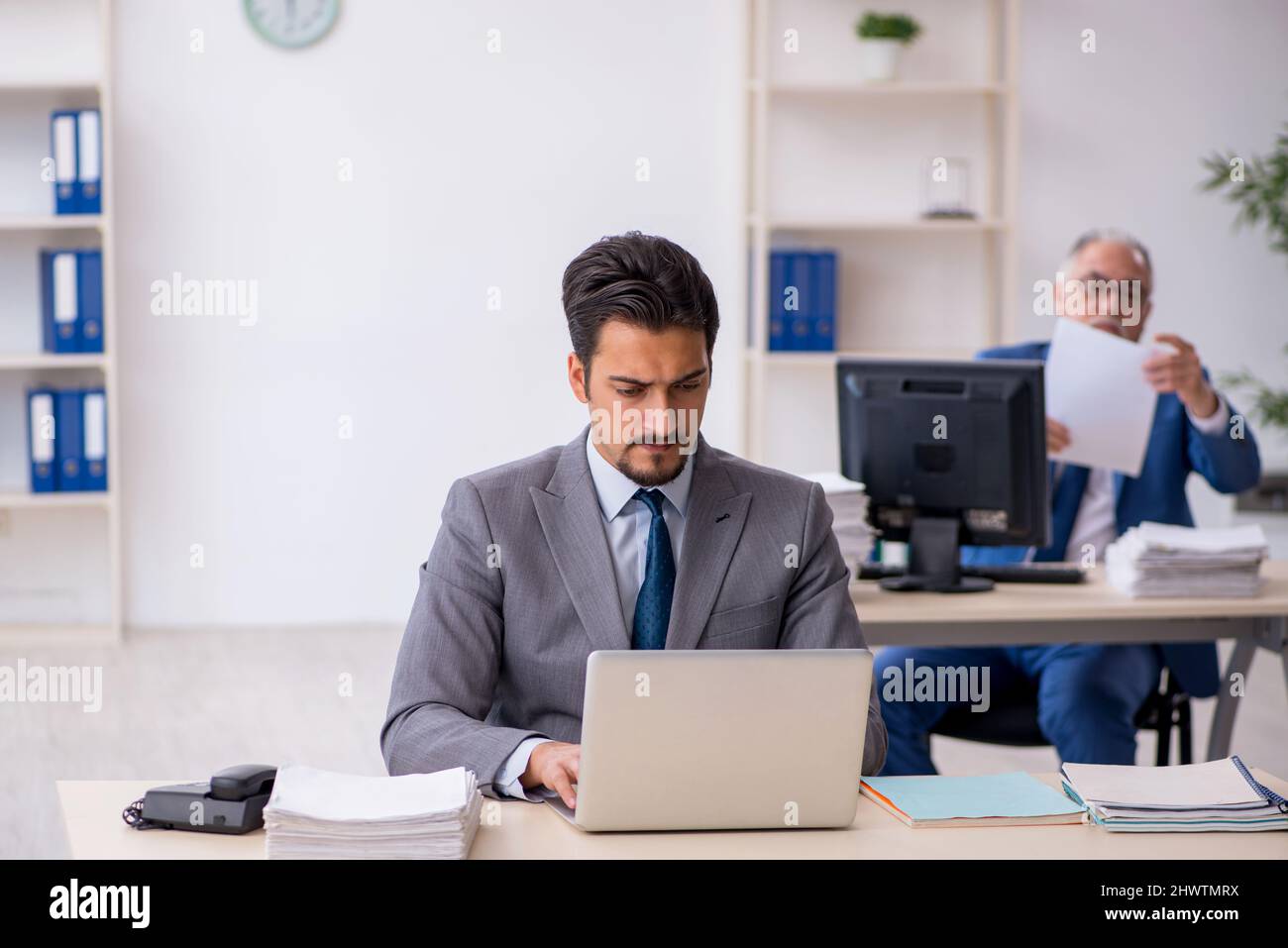 Two male employees working in the office Stock Photo - Alamy