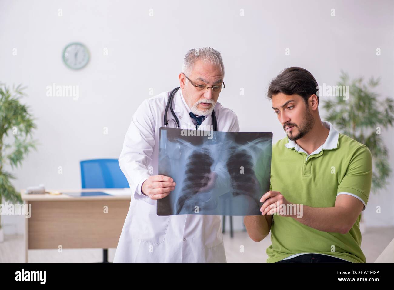 Young man visiting old doctor radiologist Stock Photo - Alamy