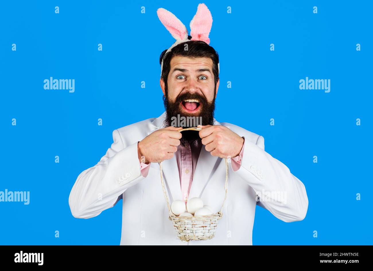 Easter tradition and symbol. Happy Bearded man in bunny ears with ...