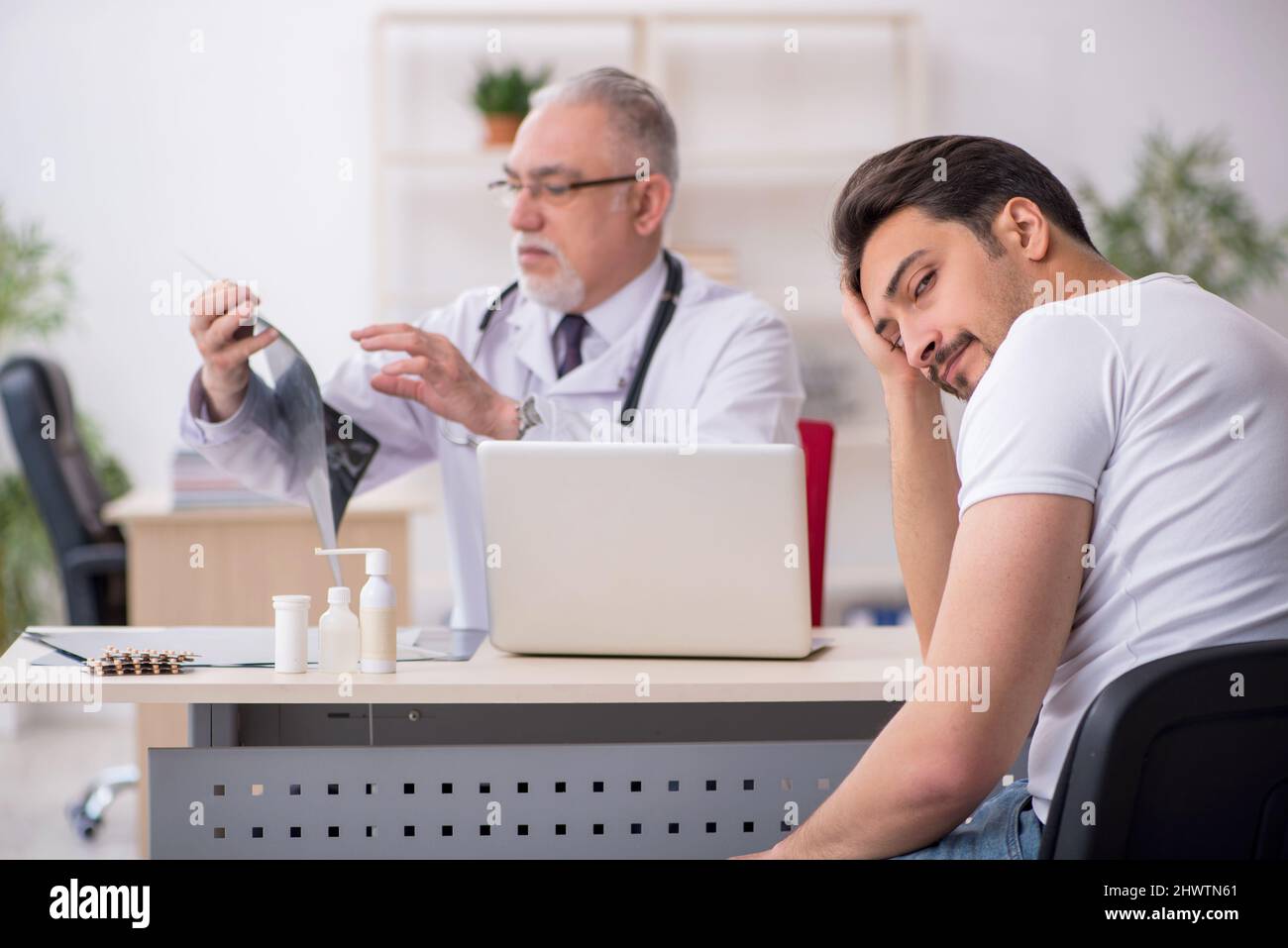 Young patient visiting old male doctor radiologist Stock Photo - Alamy