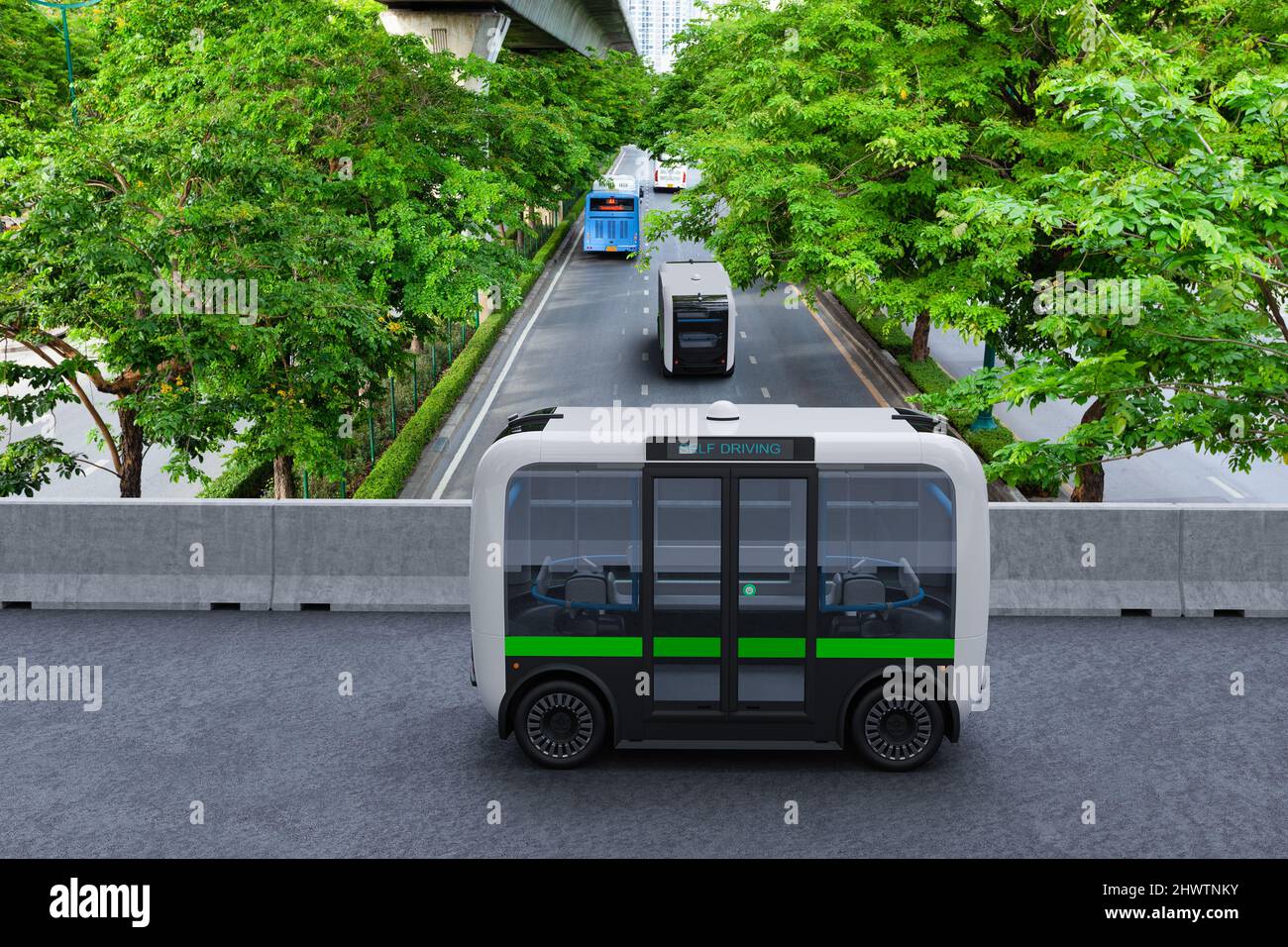Autonomous electric shuttle bus self driving across city green road ...