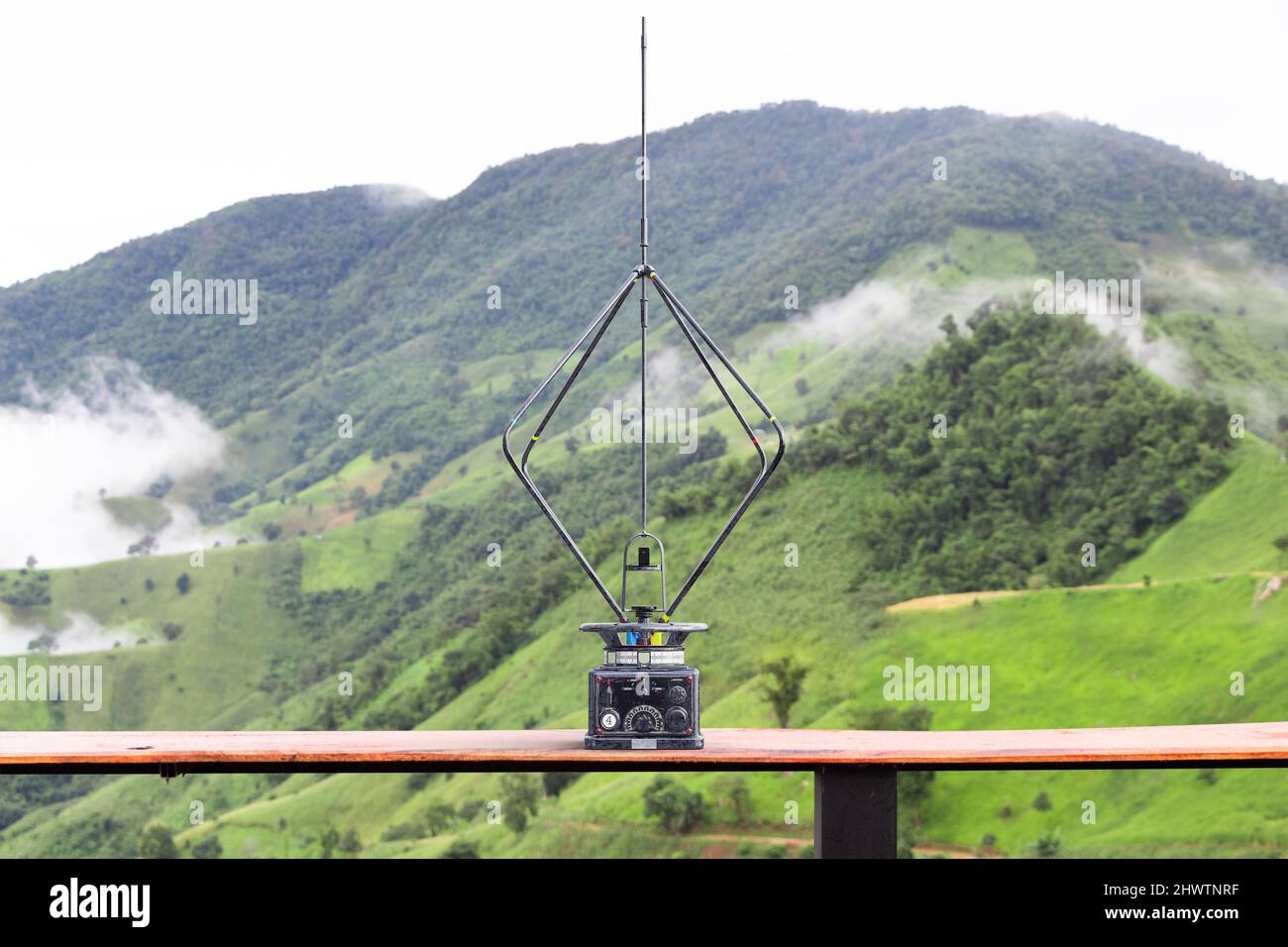 Retro military direction finder antenna on mountain view background ...