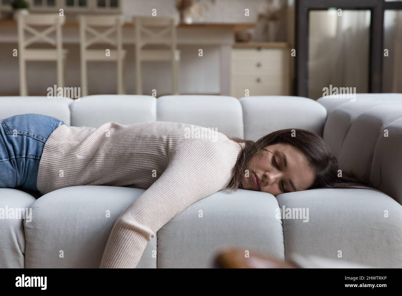 Tired unmotivated young woman have day nap on sofa Stock Photo - Alamy