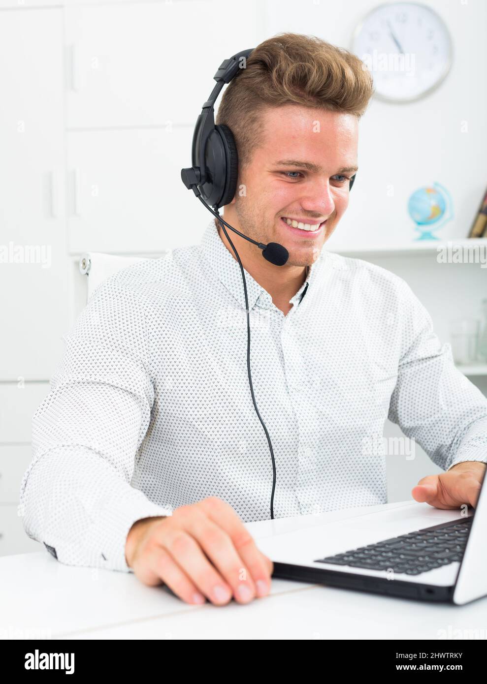 Positive call center male operator talking with client in agency Stock ...