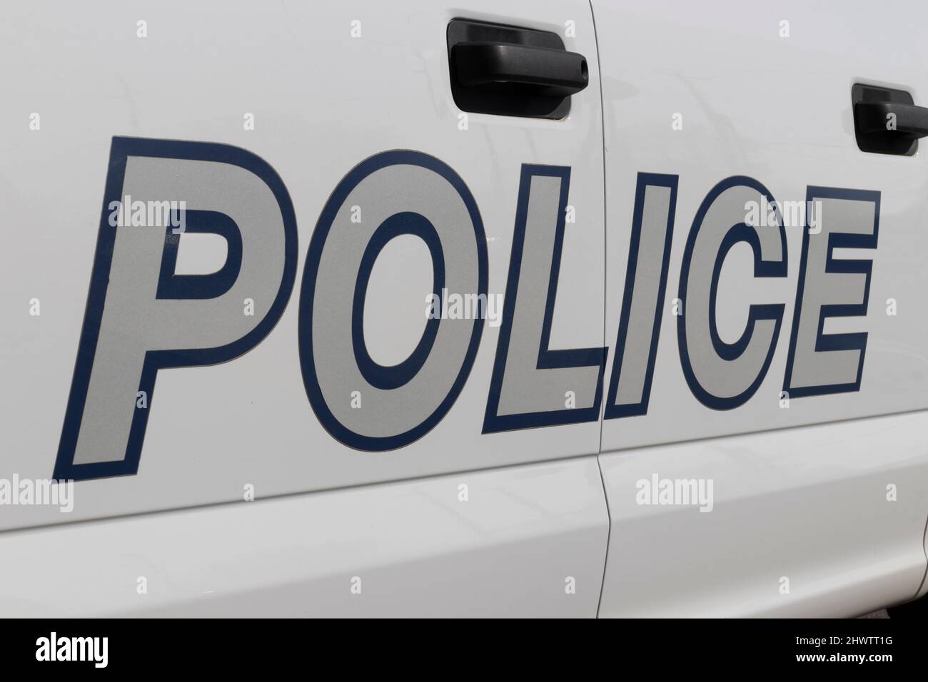 POLICE printed on the side of a police car in bold silver text with ...