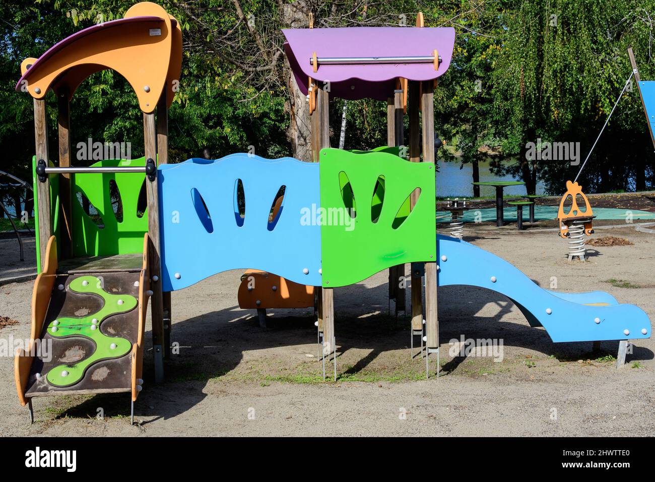 Colourful children playground with mixed plastic and metallic toys and ...
