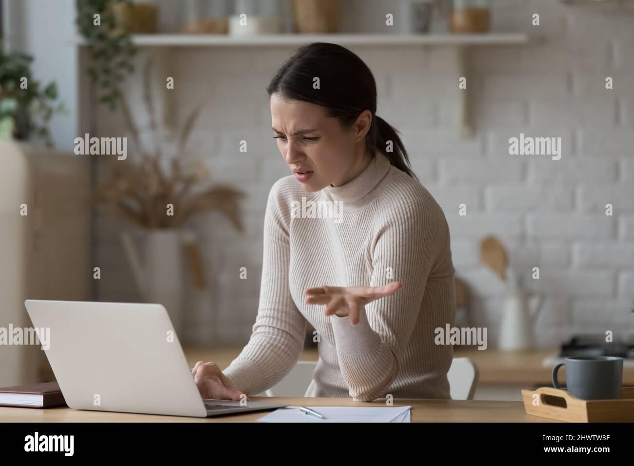 Young woman having problems with laptop usage feels irritated Stock ...