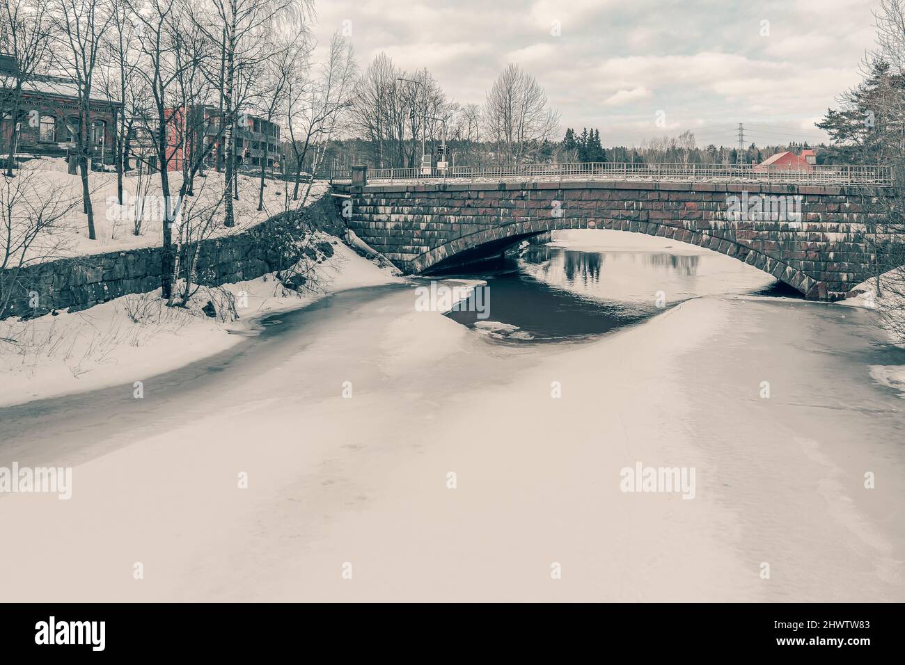 Large stone bridge over the river in winter day Stock Photo - Alamy