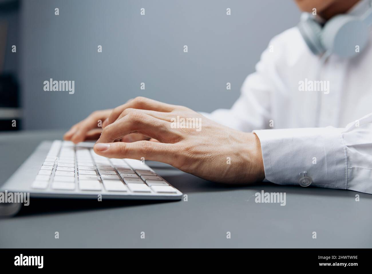 man sitting at a table with a keyboard in the office isolated ...