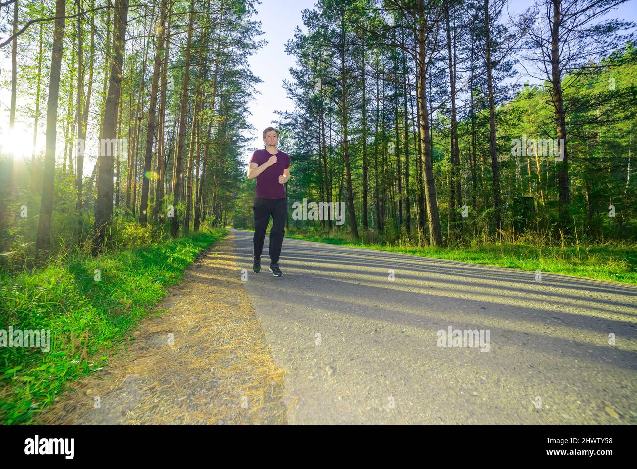 Running man jogging in city park at beautiful summer day. Sport fitness ...