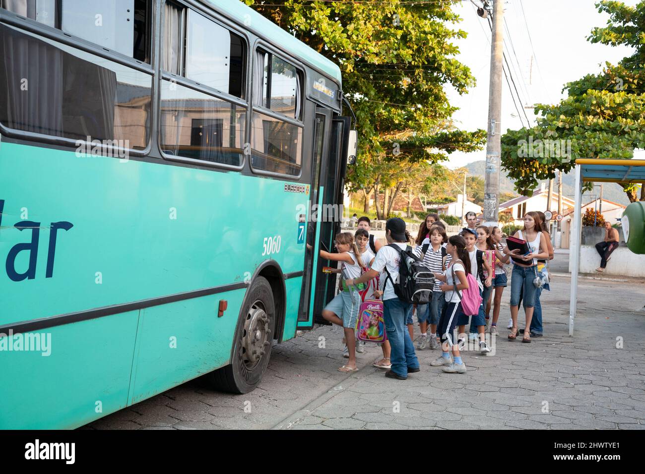 Middle school students get onto a school busl in Riberao da Ilha, Santa ...