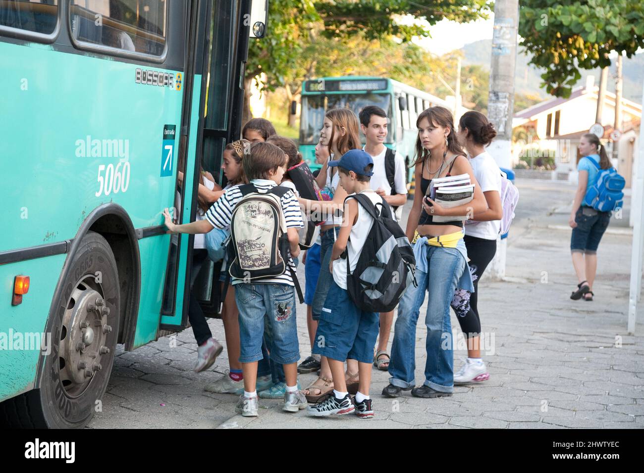 Middle school students get onto a school busl in Riberao da Ilha, Santa ...