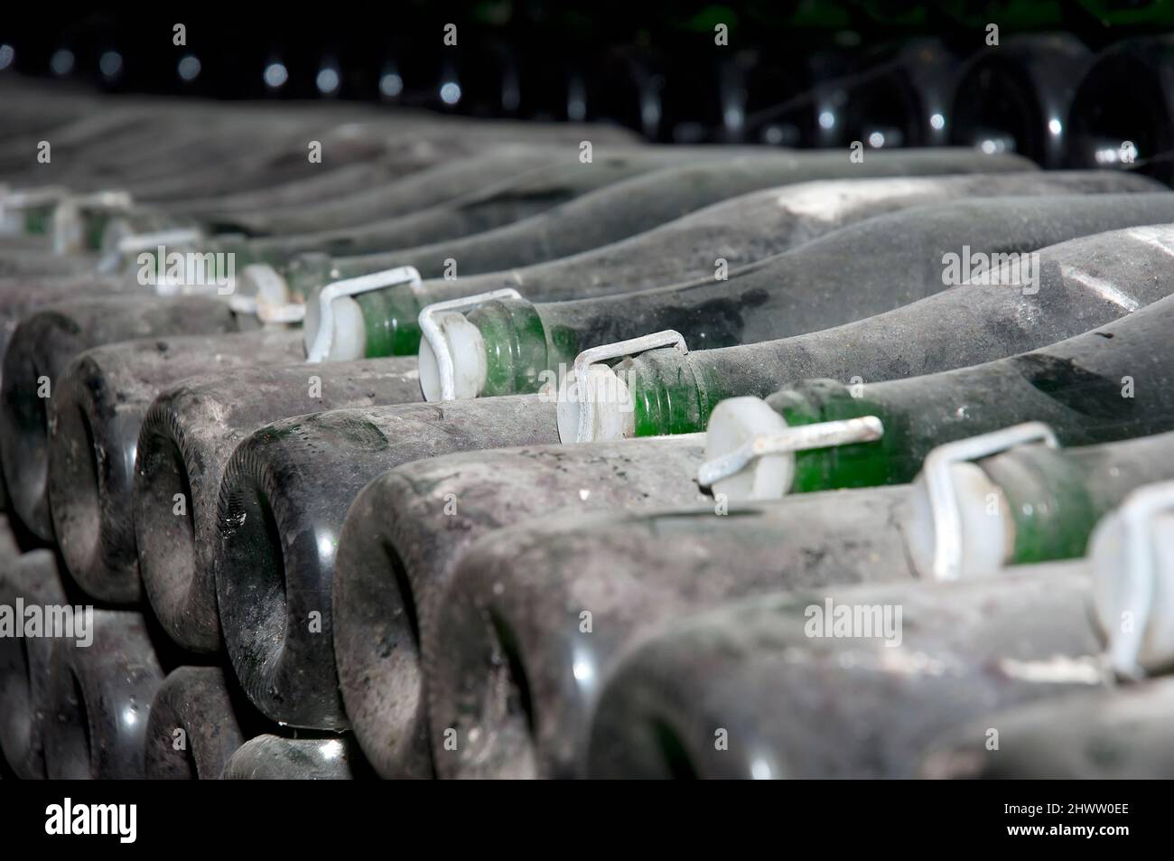 Stack of wine bottles in winery. Champagne wine storage Stock Photo - Alamy