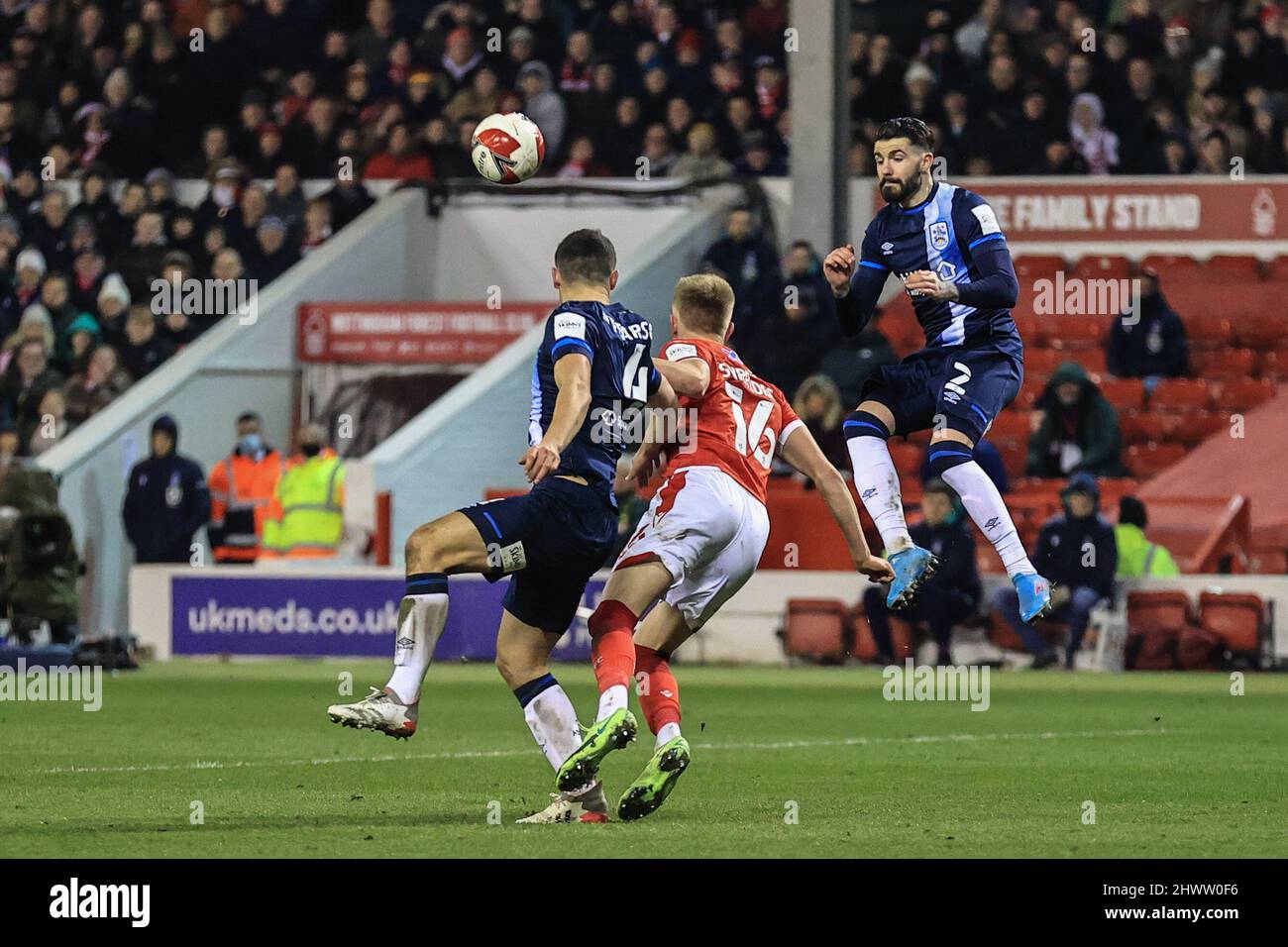 Matty Pearson #4 of Huddersfield Town heads clear to Pipa #2 of ...