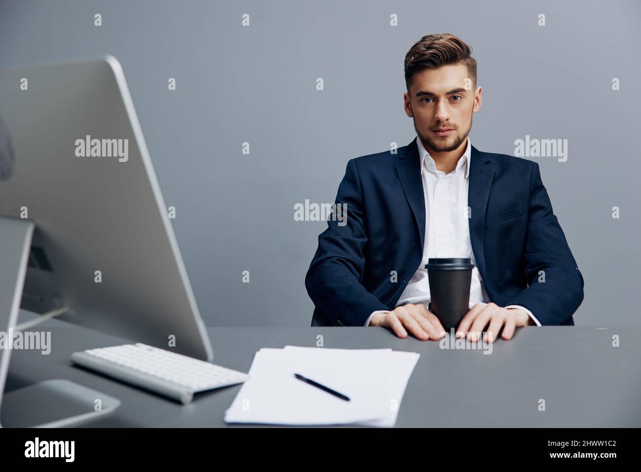 businessmen sitting at a desk in front of a computer technologies Stock ...