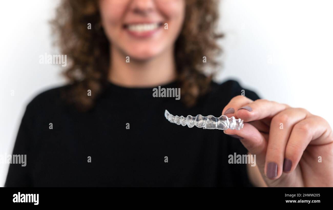 Female hand holding dental aligner retainer of dental clinic for ...
