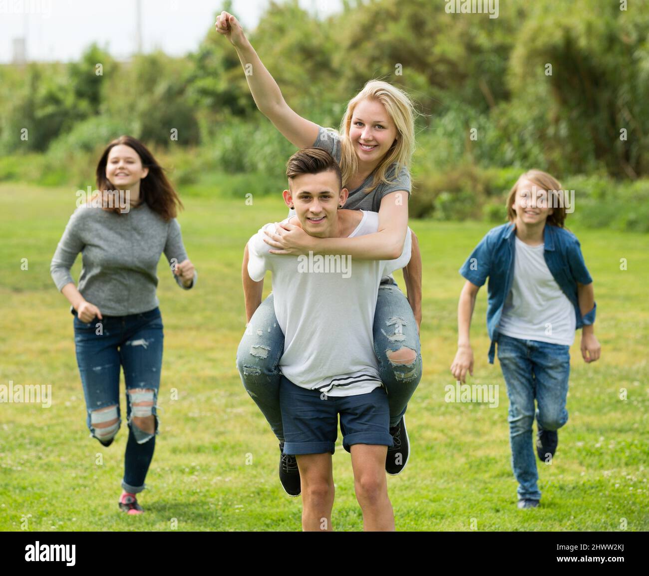 Laughing teenagers having fun and running Stock Photo - Alamy