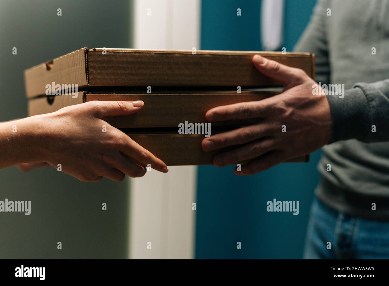 Close-up cropped shot of woman customer receiving carton boxes with ...