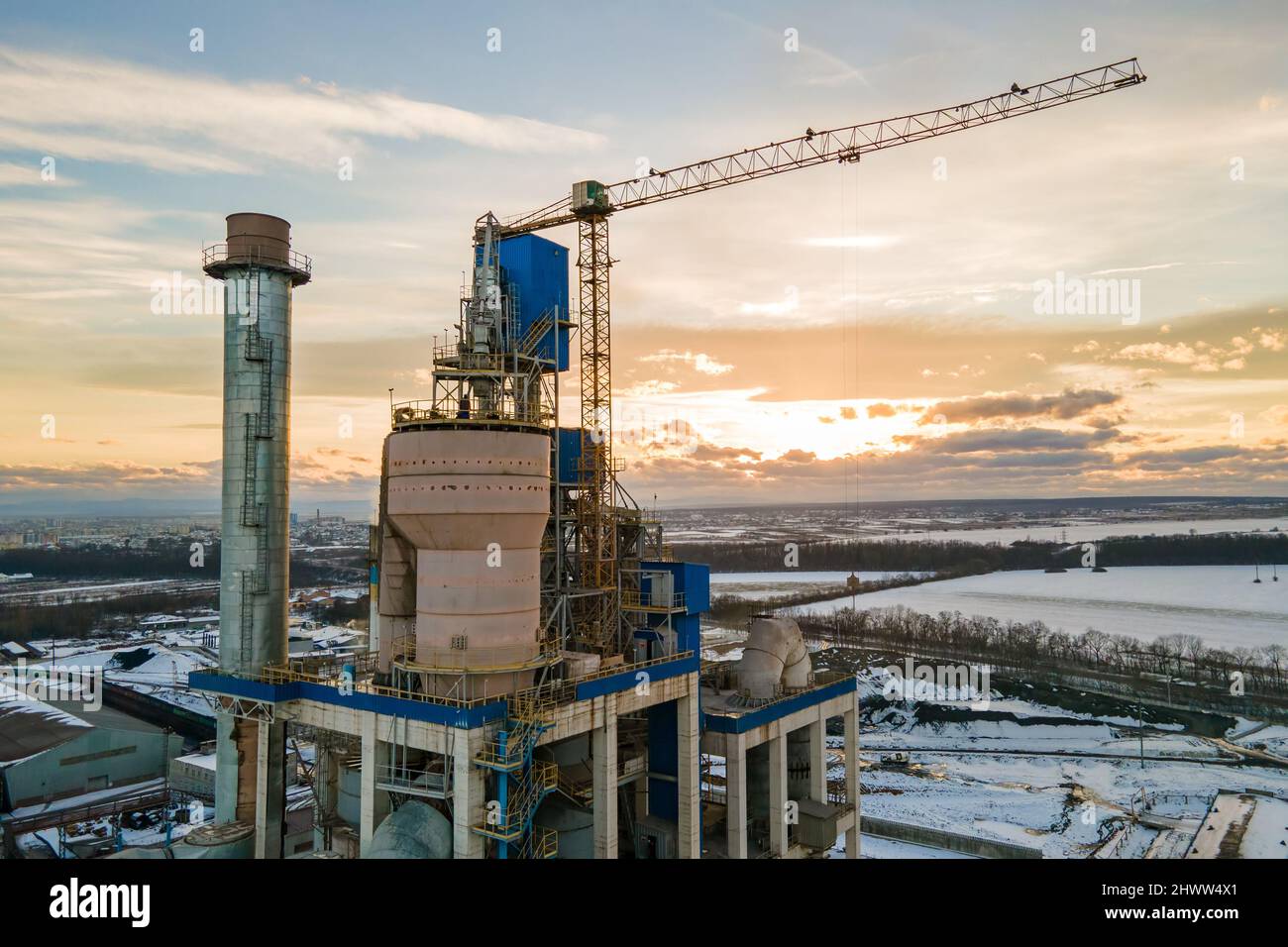 Aerial view of cement plant with high factory structure and tower crane ...