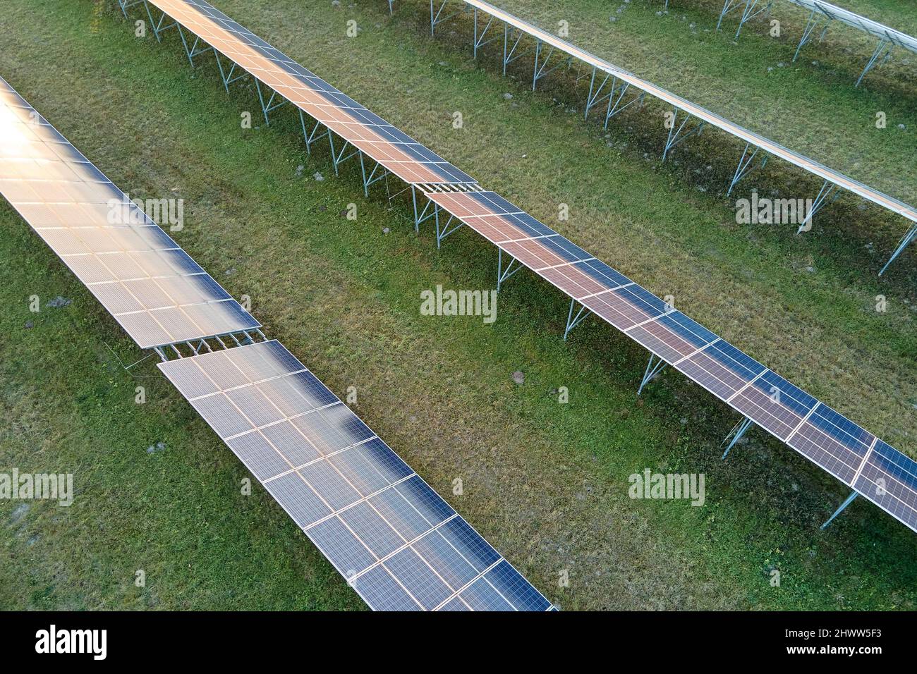 Aerial view of large sustainable electrical power plant with rows of solar photovoltaic panels ...