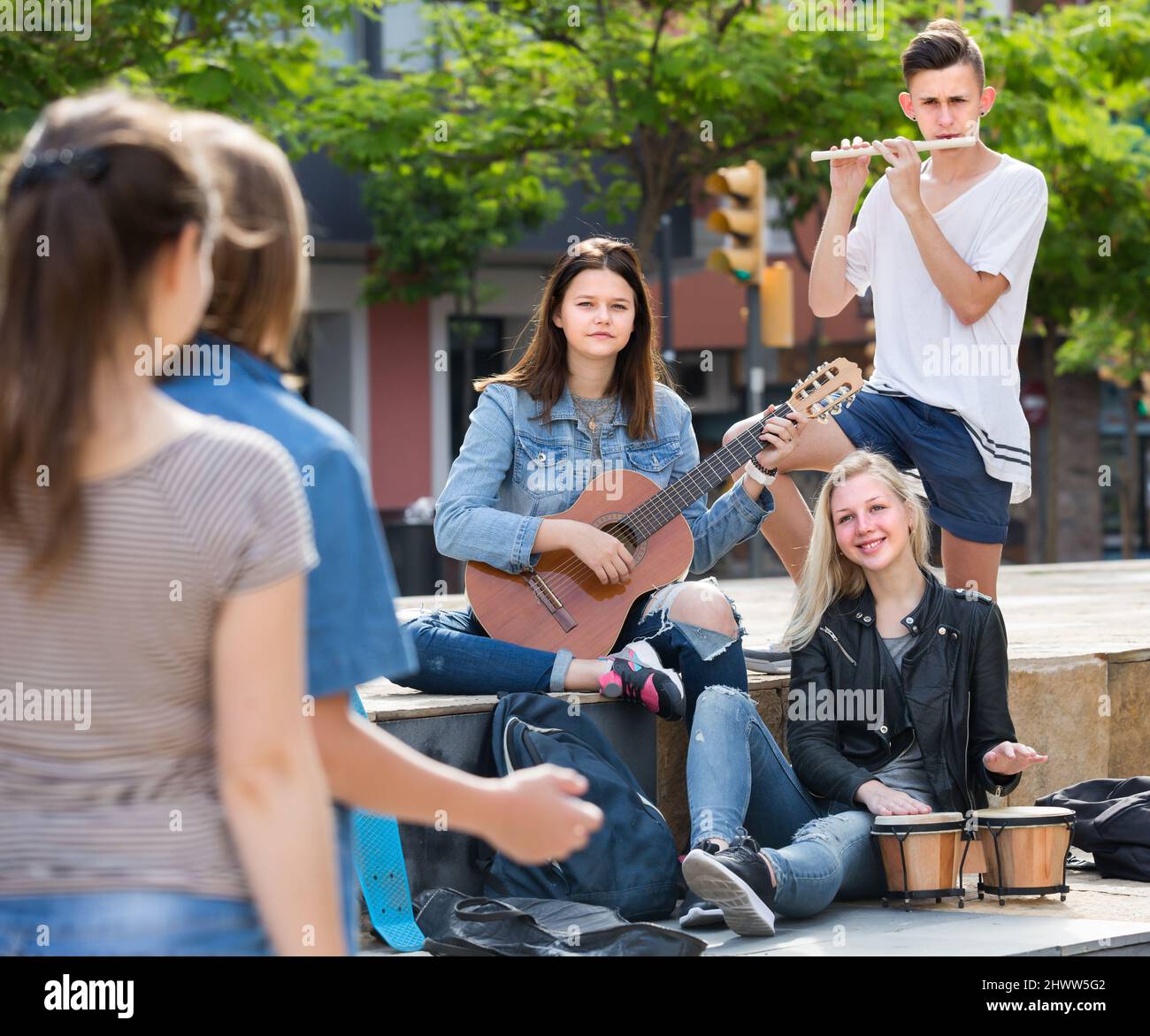 Adult girls and boys with musical instruments Stock Photo - Alamy