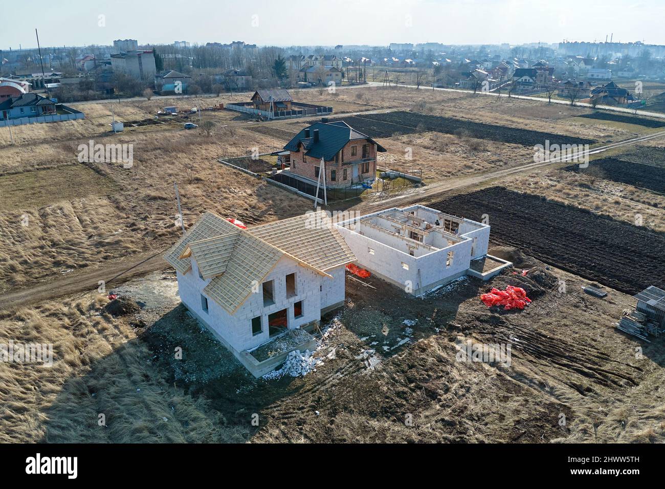 Aerial view of unfinished frame of private house with aerated ...