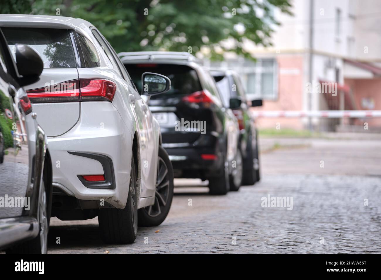 Cars parked in line on city street side. Urban traffic concept Stock ...
