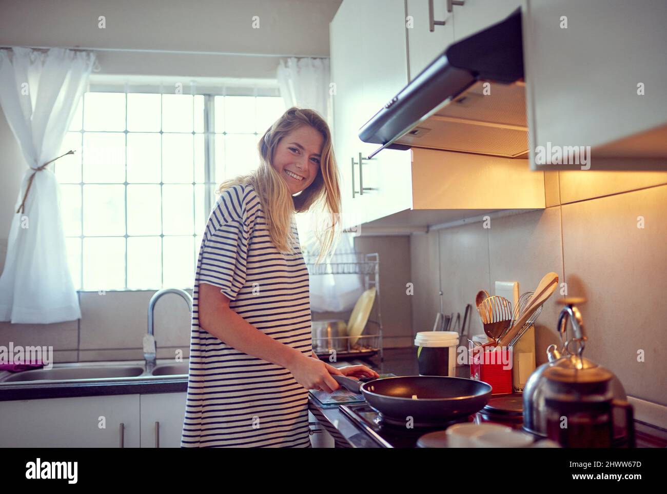 Preparing one of her classic dishes. Portrait of an attractive young ...