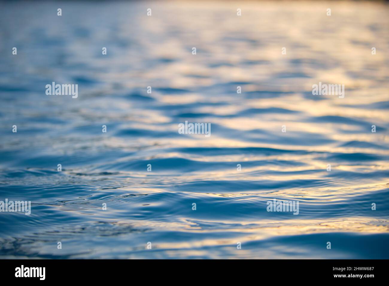 Closeup seascape surface of blue sea water with small ripple waves ...