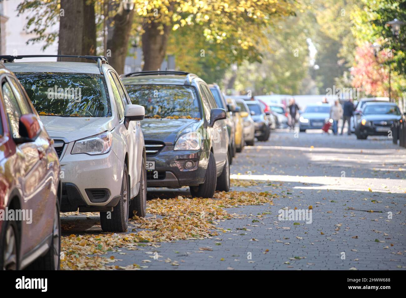 City traffic with many cars parked in line on street side Stock Photo ...