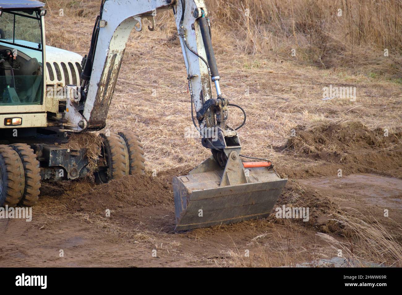 Earth moving tractor preparing place for future house foundation ...