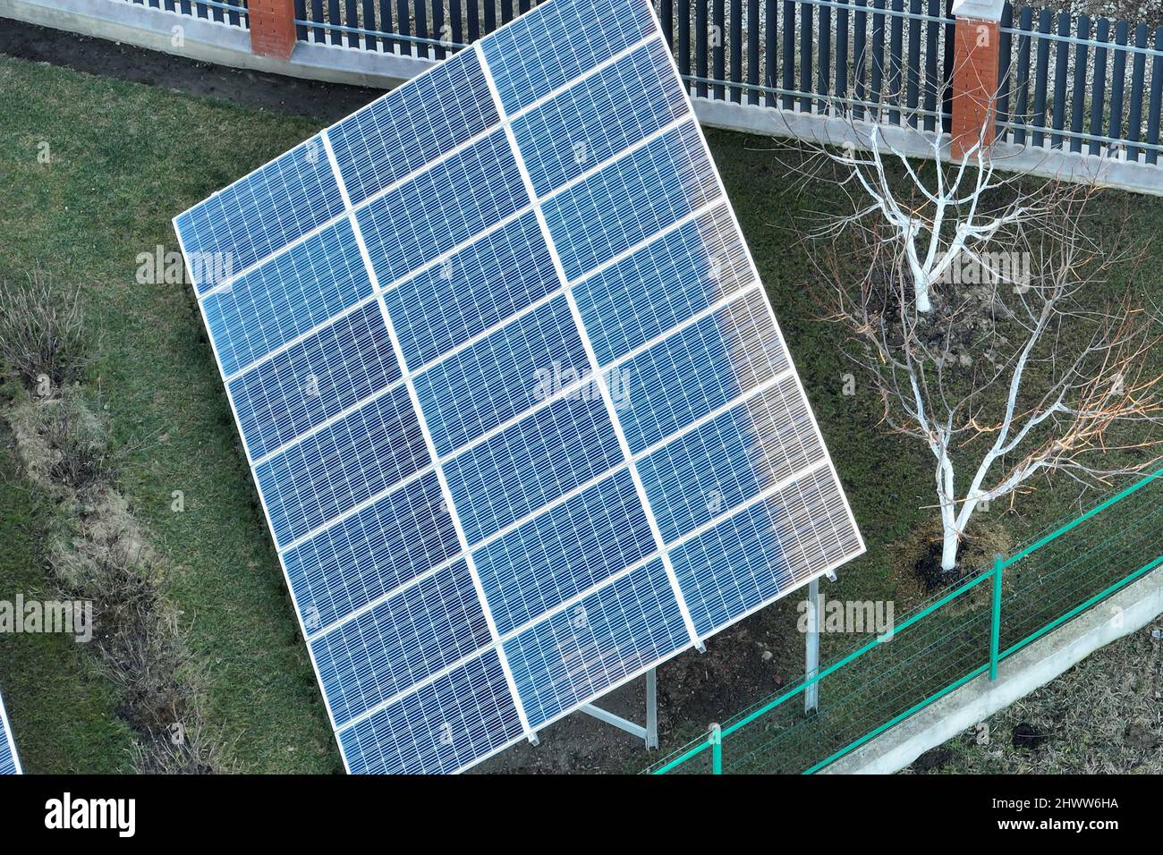 Solar photovoltaic panels mounted on stand-alone frame on backyard ...