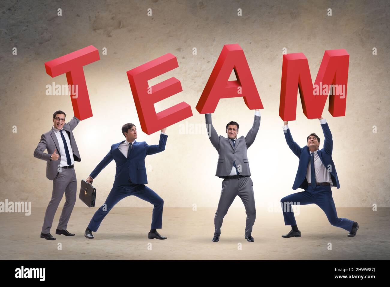Teamwork concept with the people carrying team letters Stock Photo - Alamy