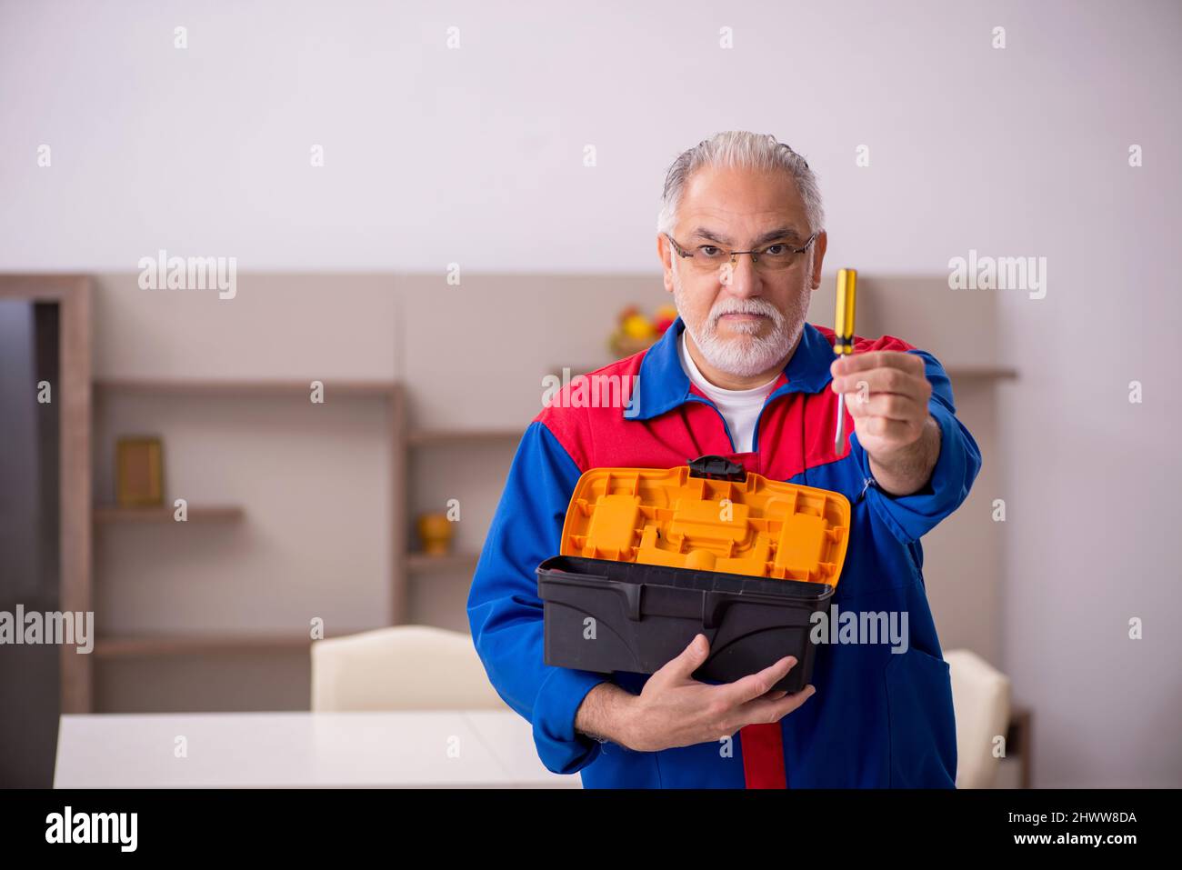Old carpenter working at home Stock Photo - Alamy