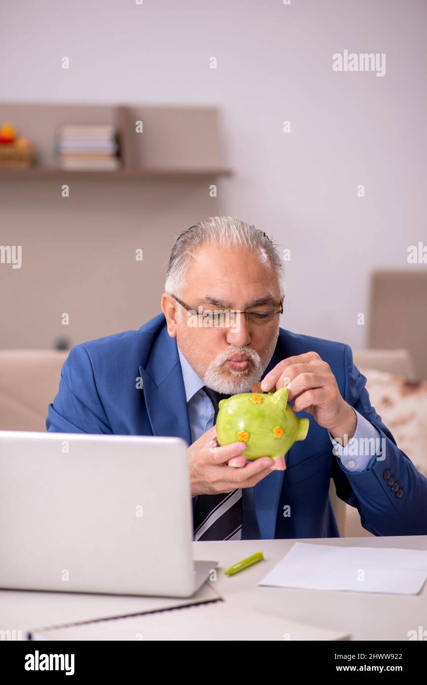 Old boss working from home in retirement concept Stock Photo - Alamy