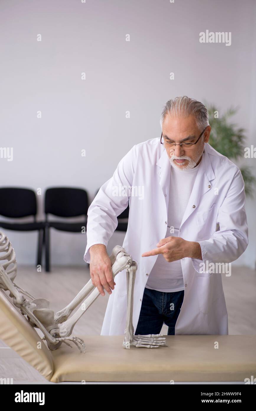 Old doctor with skeleton at the hospital Stock Photo - Alamy