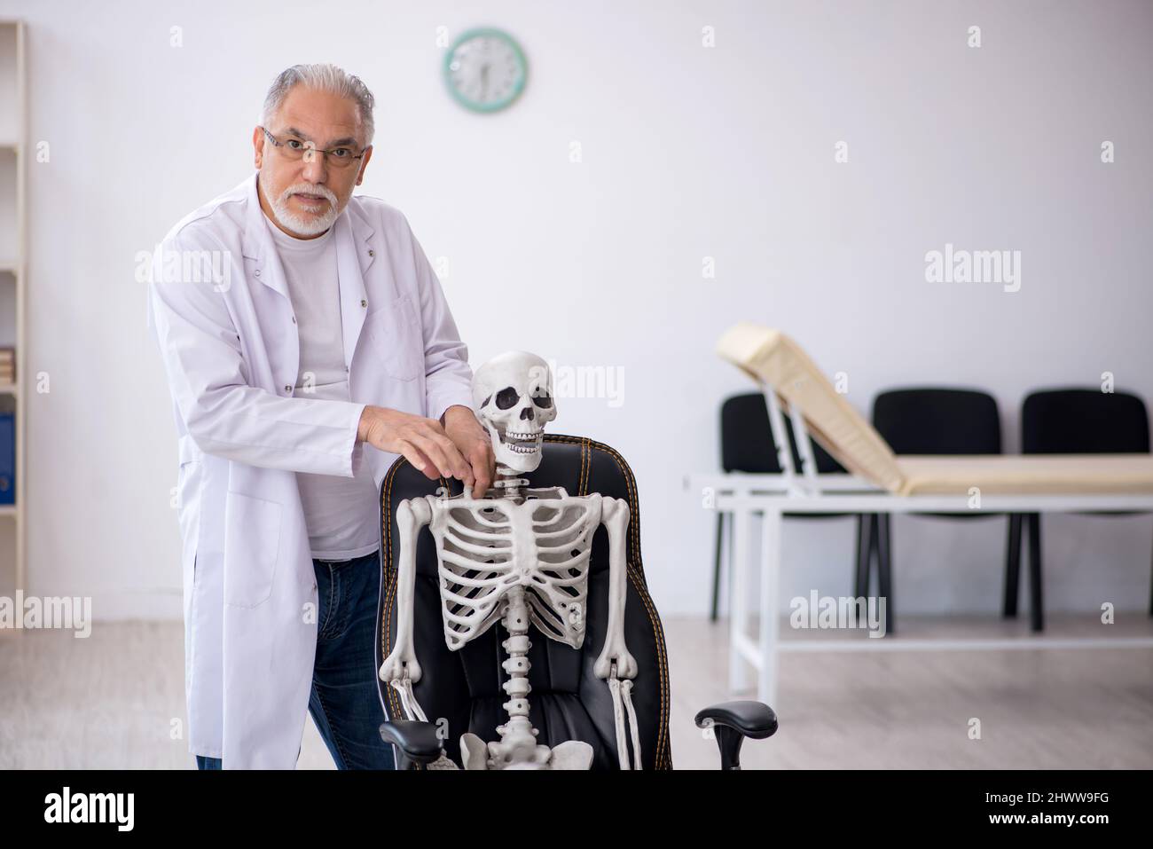 Old doctor with skeleton at the hospital Stock Photo - Alamy
