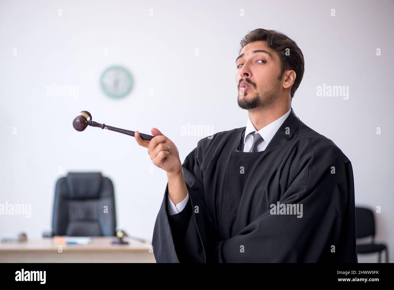 Young judge working in the courthouse Stock Photo - Alamy