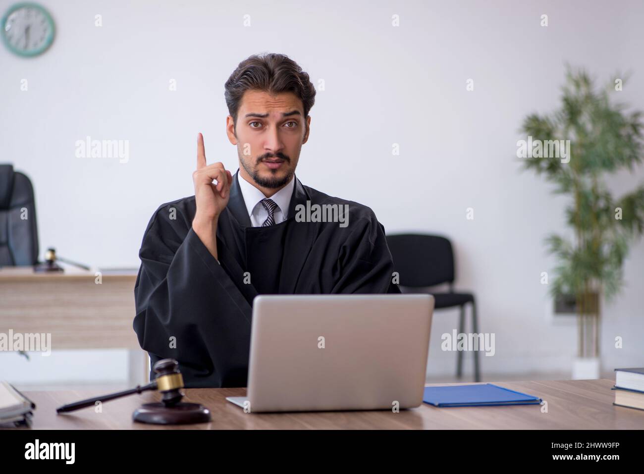 Young judge working in the courthouse Stock Photo - Alamy