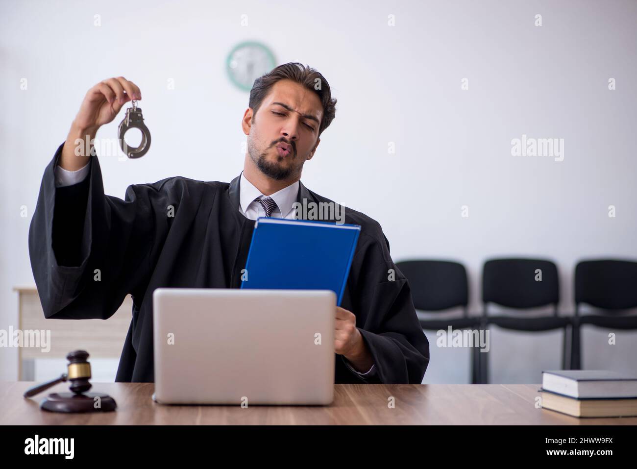 Young judge working in the courthouse Stock Photo - Alamy