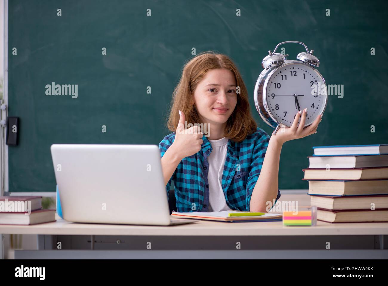 Young girl student in time management concept Stock Photo - Alamy