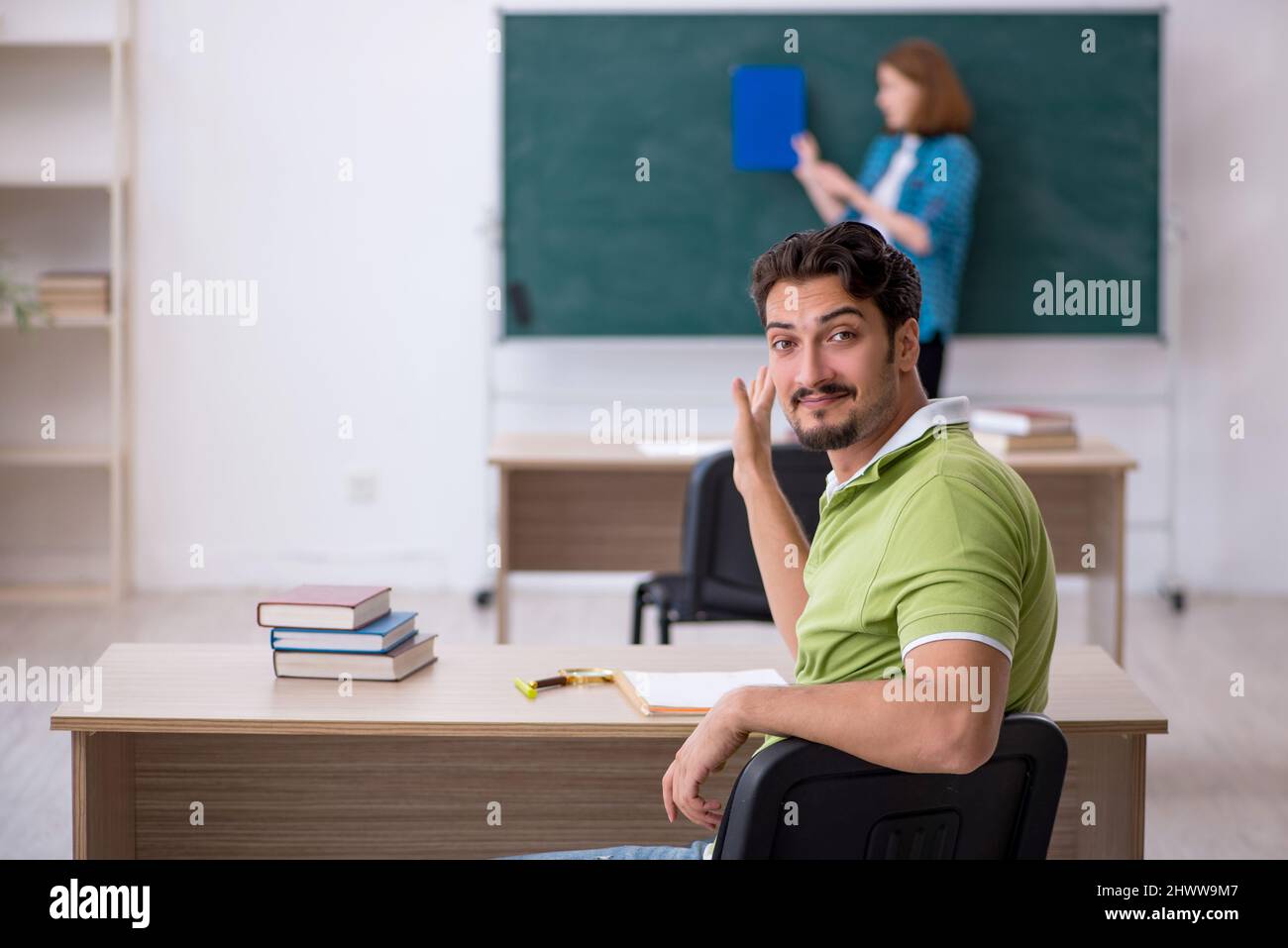 Young teacher teaching student in the classroom Stock Photo - Alamy