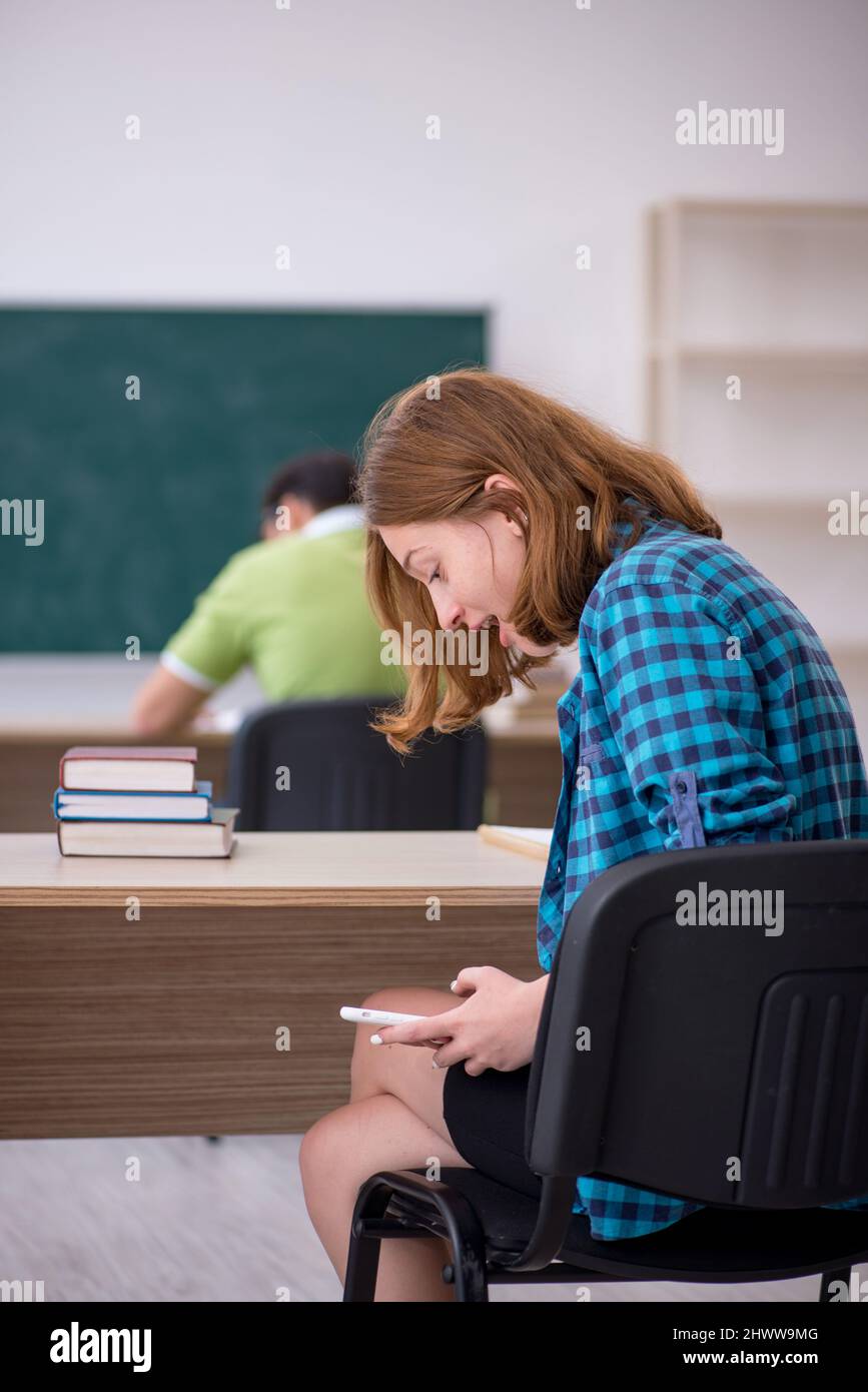 Two students sitting in the class Stock Photo - Alamy