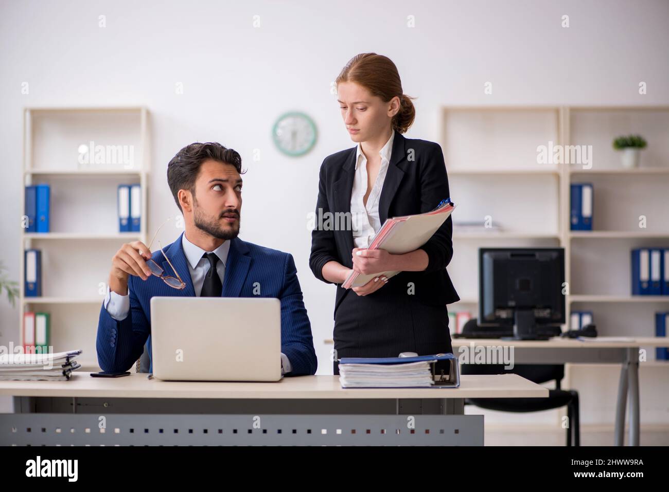 Two colleagues sitting in the office Stock Photo - Alamy